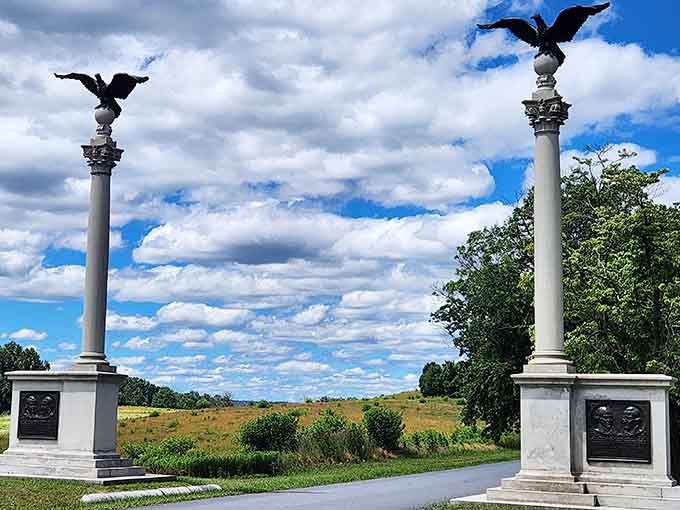 Majestic eagle-topped columns frame endless Pennsylvania sky, standing sentinel over fields where history's course changed during one brutal winter.
