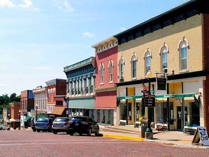 Those colorful storefronts aren't trying to impress anyone, they just happen to create Main Street magic anyway.