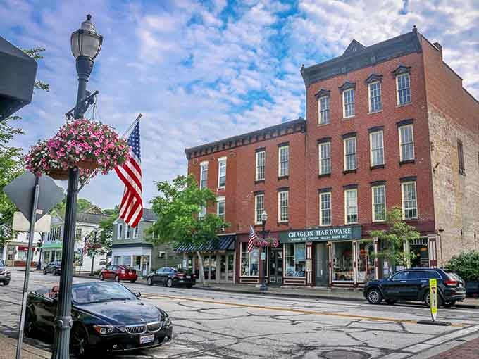 Historic storefronts line the streets where American flags wave and hanging flower baskets add splashes of color overhead.