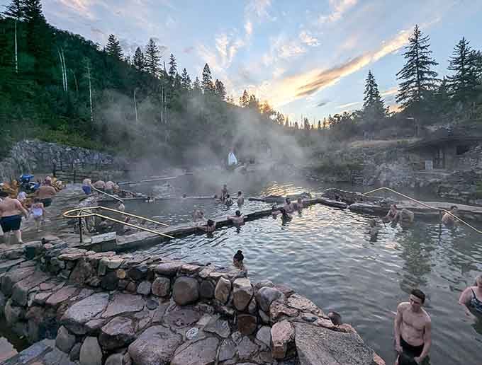 Steam rising off natural pools at sunset looks like the earth is exhaling pure relaxation into the mountain air.