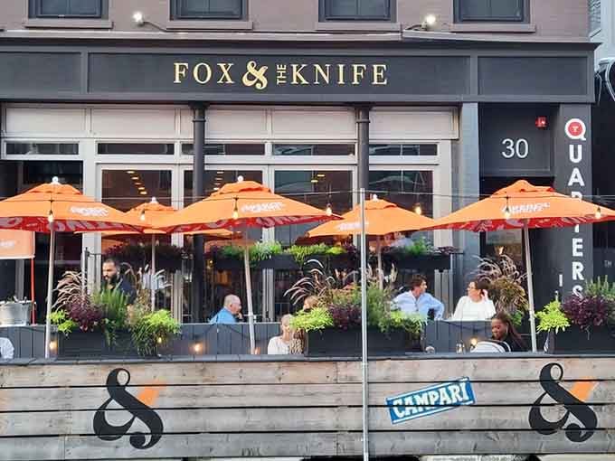 That outdoor patio situation is calling your name, complete with orange umbrellas that practically scream "European summer vacation."