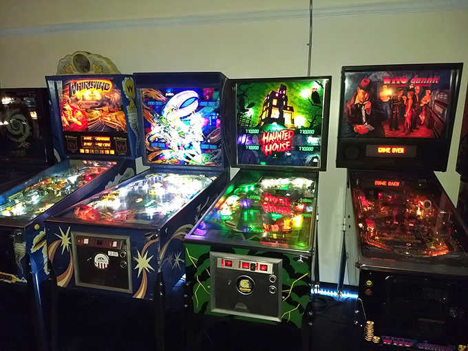 Rows of vintage pinball machines stand ready like soldiers of joy, waiting to light up your afternoon.