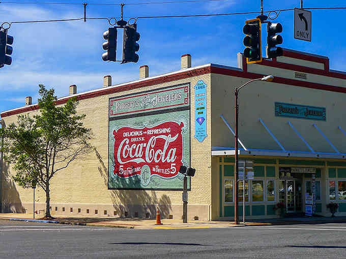 Historic Coca-Cola murals remind you this town once had more millionaires than sense, and the evidence remains.