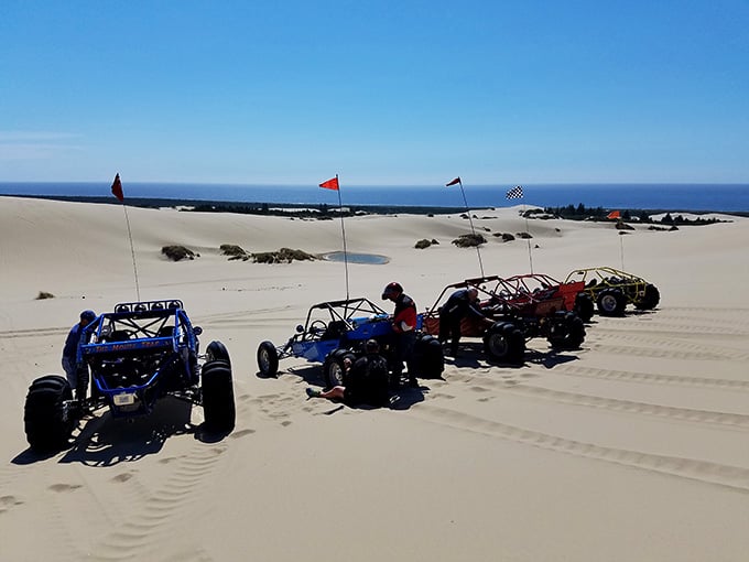A convoy of colorful dune buggies lined up like they're about to storm the beaches of Normandy, sandy edition.