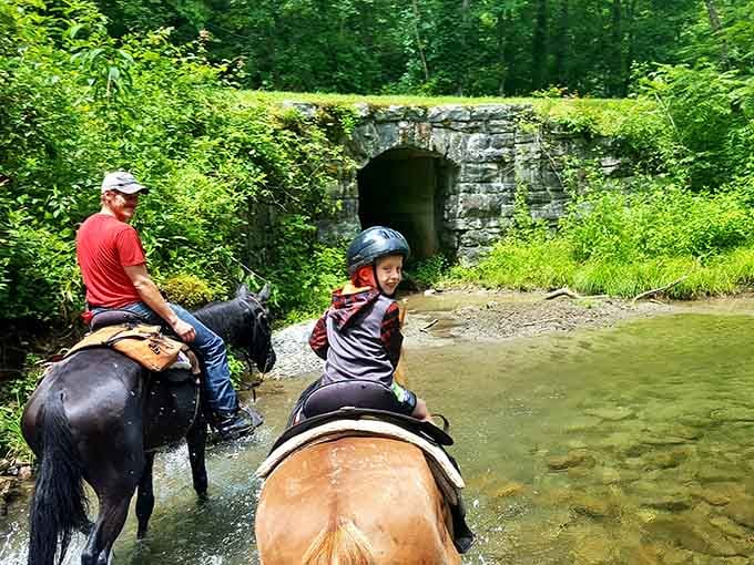 Nothing says adventure like crossing a mountain stream on horseback while a stone tunnel watches over you.