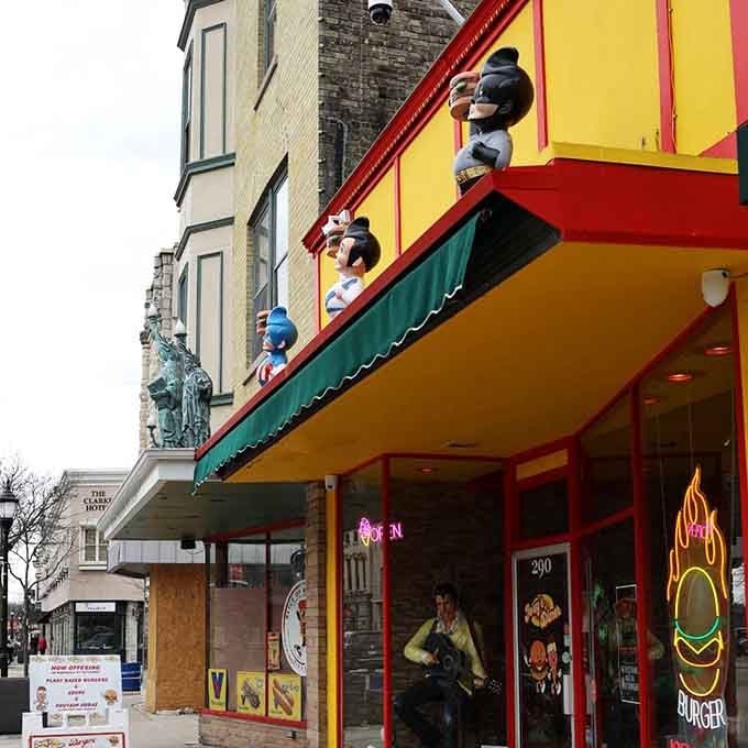 The neon burger sign glowing in the window is basically saying "your diet can wait until tomorrow, friend."