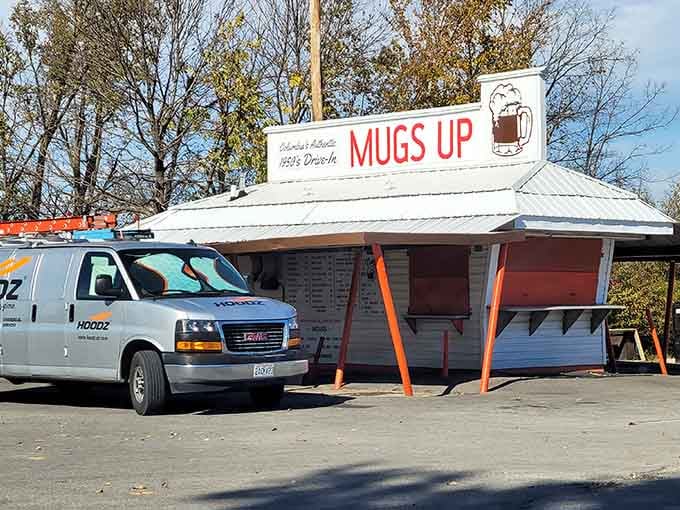 Classic drive-in architecture meets autumn sunshine, where that white metal roof has sheltered generations of burger lovers seeking simple perfection.