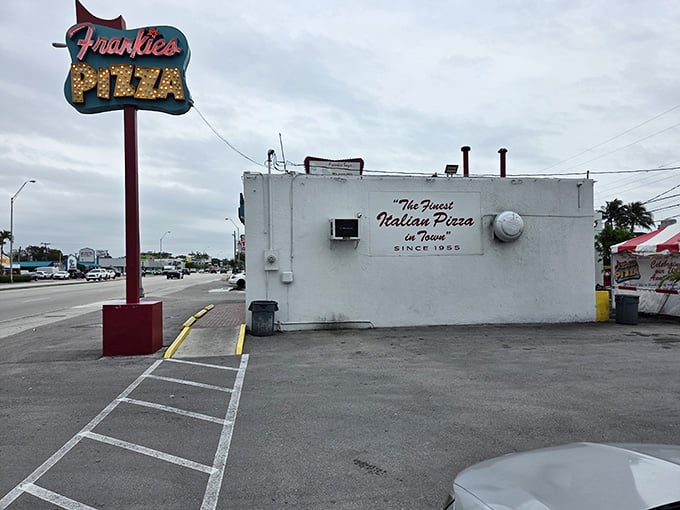 The classic roadside sign stands tall like a monument to simpler times when good pizza was all you needed.
