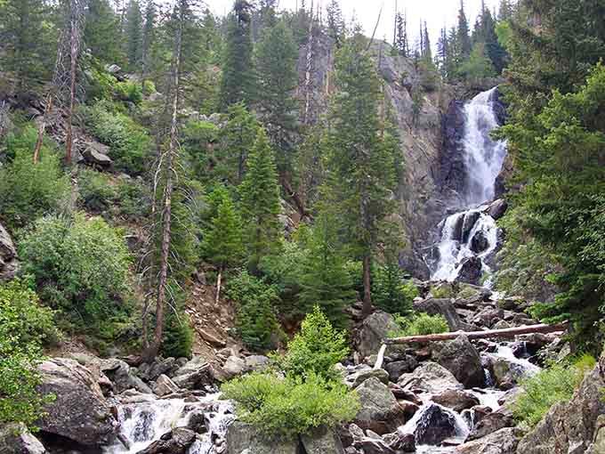 When a waterfall drops 280 feet through a Rocky Mountain canyon, it doesn't whisper—it roars with authority.