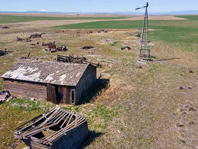 An aerial view reveals the extent of Kent's abandonment, with collapsed structures scattered across the high desert landscape like forgotten memories.