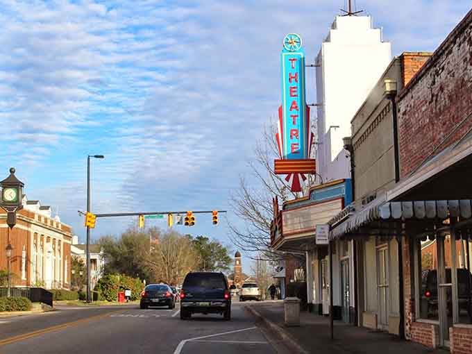 That vintage theatre sign glowing against the brick buildings is basically downtown Greenville saying "we've got culture and we're not afraid to light it up."