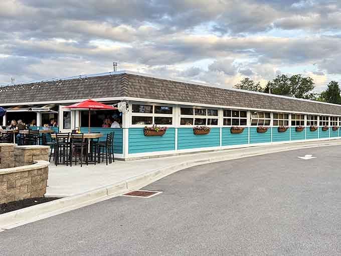 That turquoise exterior with hanging flower baskets isn't just pretty, it's your beacon to fried chicken paradise.