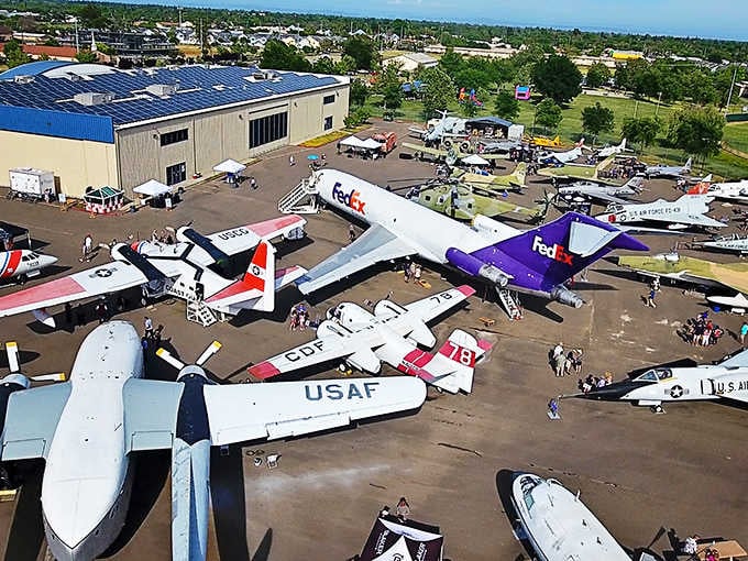 An aerial view reveals dozens of aircraft arranged like the world's most impressive parking lot for flying machines.