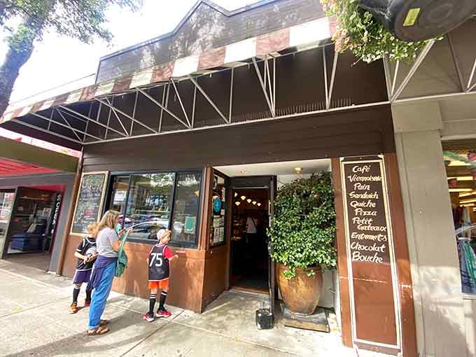 The storefront beckons like a siren song, promising buttery treasures that'll derail your diet before noon.