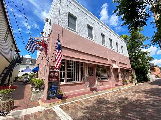 That pink-hued exterior flying the Greek and American flags is your first clue that something wonderfully unexpected awaits inside this St. Augustine treasure.