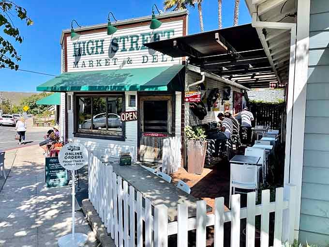 That classic green awning and white picket fence hide sandwich secrets that'll change your lunch game forever.