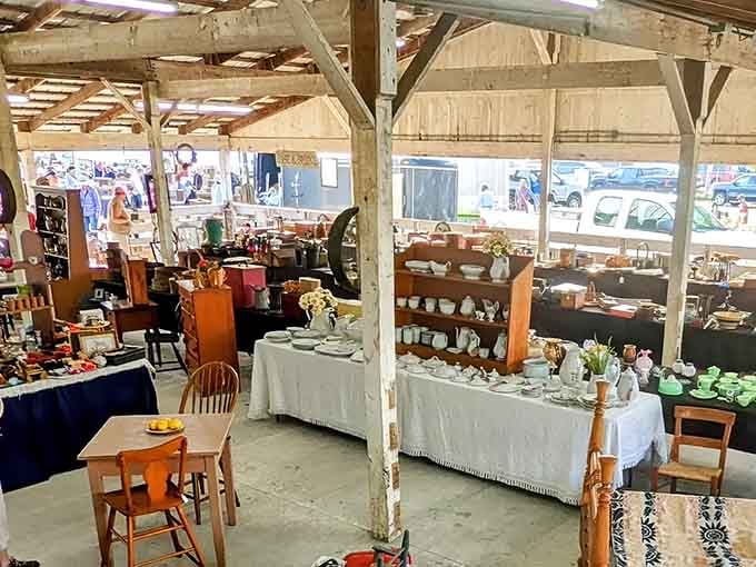 Sunlight streams through open-air pavilions where vintage glassware and wooden furniture wait for their next chapter to begin.