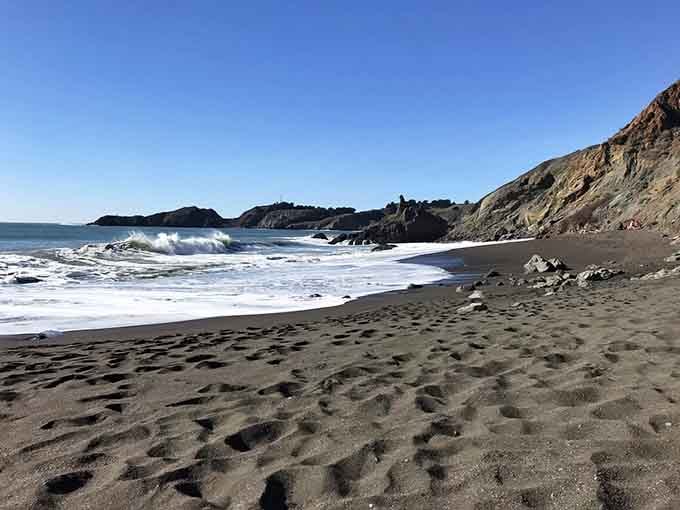 Those footprints in the dark sand tell stories of adventurers who earned this view one stair at a time.