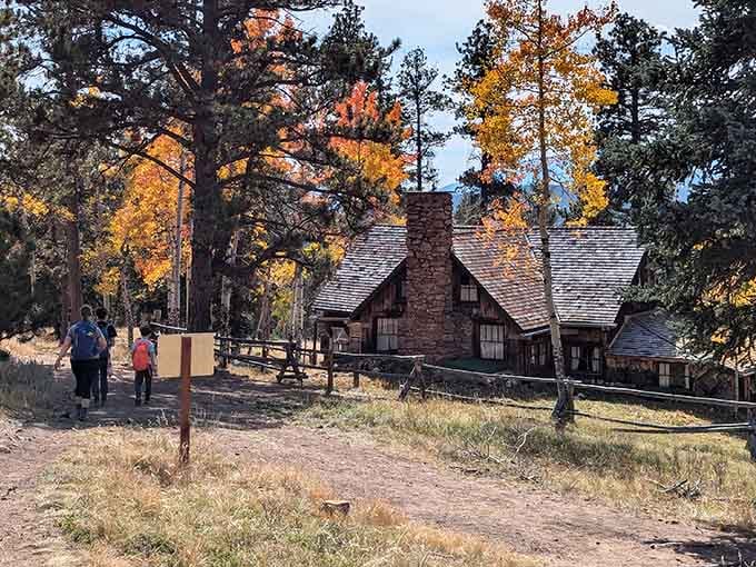 Hikers explore the trails past historic stone buildings surrounded by golden aspens, blending outdoor adventure with fascinating glimpses into Colorado's past.