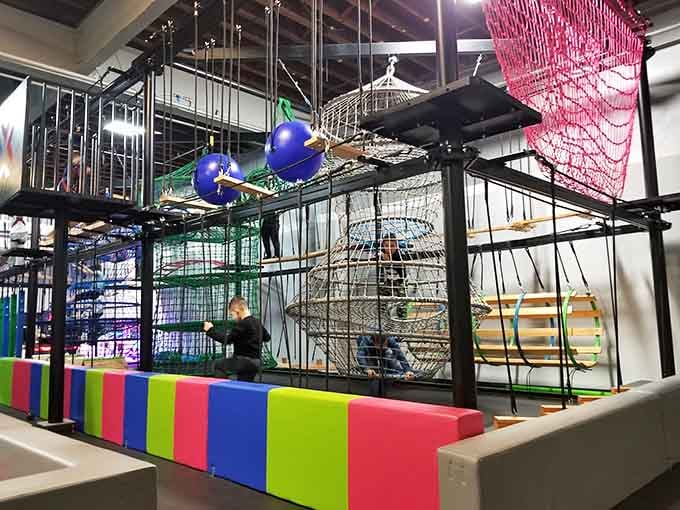 That towering obstacle course stretching toward the ceiling makes American Ninja Warrior look like a warm-up routine.