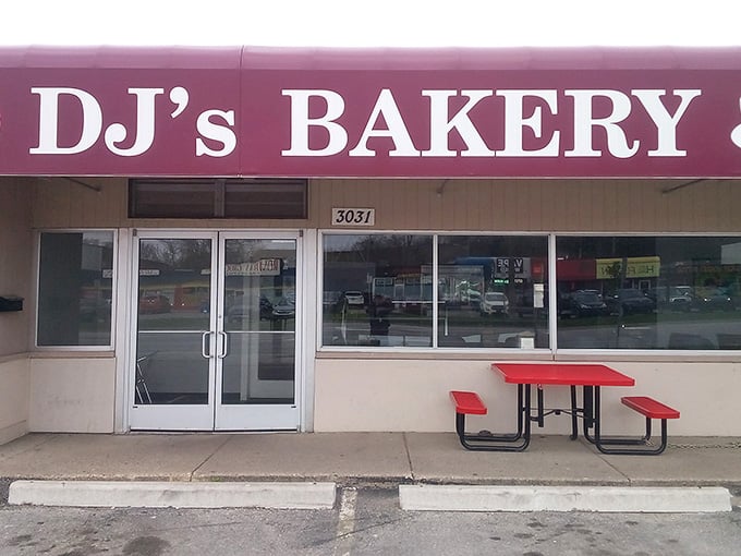 The red picnic table outside isn't just furniture; it's where donut-induced happiness happens rain or shine.
