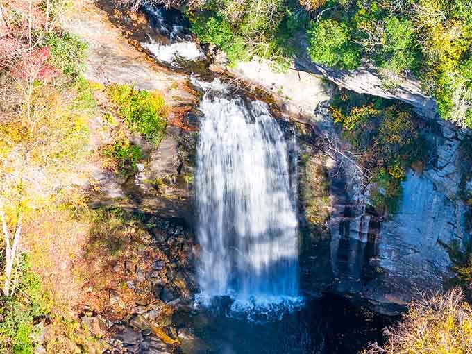 Sixty feet of pure mountain magic cascading over ancient rock like nature's own grand entrance.
