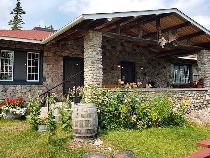 The charming stone and timber lodge welcomes visitors with beautiful gardens and classic North Woods architecture that feels like home.