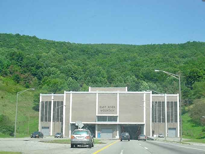 That moment when a mountain gets its own front door, complete with brutalist architecture and serious concrete vibes.