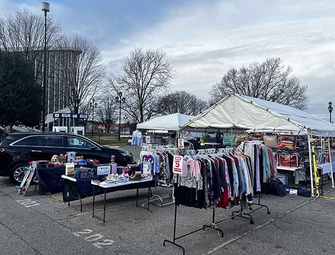 Clothing racks stand ready for fashion archaeologists seeking vintage gems among the carefully curated outdoor merchandise displays.