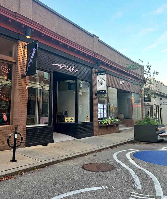 The entrance of Weesh Bake Shop, with its purple sign, hints that something deliciously fun is happening inside this Roslindale gem.