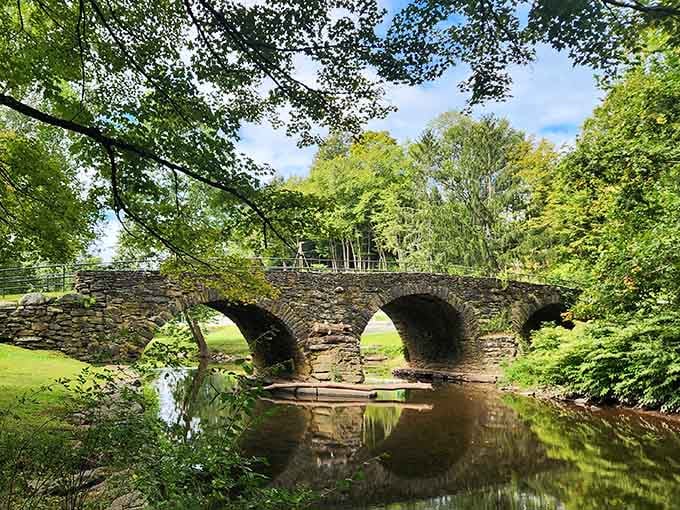 That gorgeous stone arch bridge reflecting in the creek? That's your destination, and it's absolutely worth the drive.