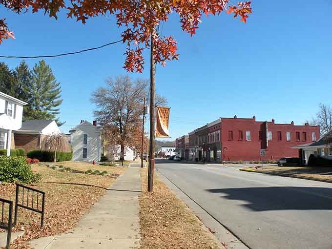 Autumn leaves frame this peaceful main street where time slows down and neighbors still wave to passing strangers.