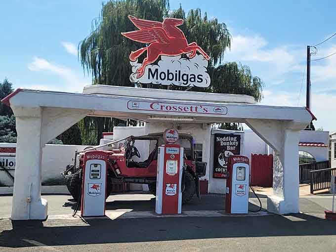 When vintage gas pumps meet comfort food, magic happens under that glorious Mobilgas sign welcoming hungry travelers.