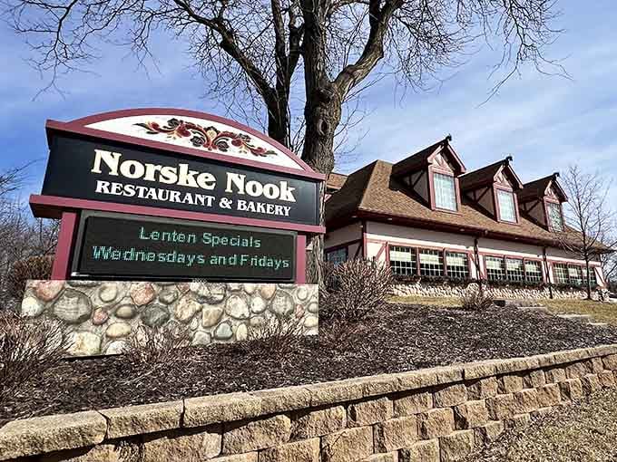 The Norske Nook sign proudly announces this Norwegian-inspired restaurant where homemade pies have become a legendary Wisconsin tradition worth experiencing.