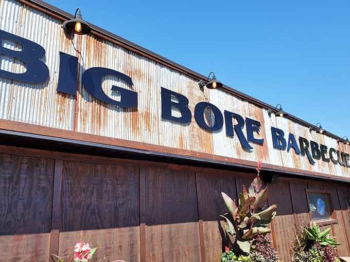 That weathered corrugated metal facade tells you everything: this place prioritizes smoke over style, and your taste buds will thank them.