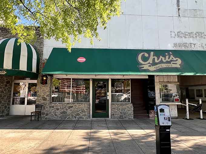 That green awning isn't just decoration, it's been beckoning hungry souls to hot dog heaven for generations.