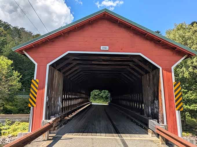 That cheerful red exterior isn't just pretty, it's been welcoming travelers across the Ware River for over a century.