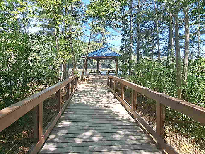 This charming wooden bridge leads to a peaceful gazebo, offering scenic views and perfect rest spots along the waterfall trail.