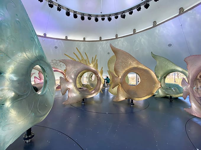 Step inside this luminous pavilion where translucent fish glow like stained glass windows in an underwater cathedral.