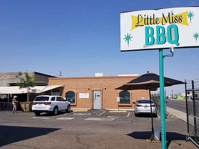 That cheerful retro sign promises smoky treasures, and spoiler alert: it delivers beyond your wildest brisket dreams.