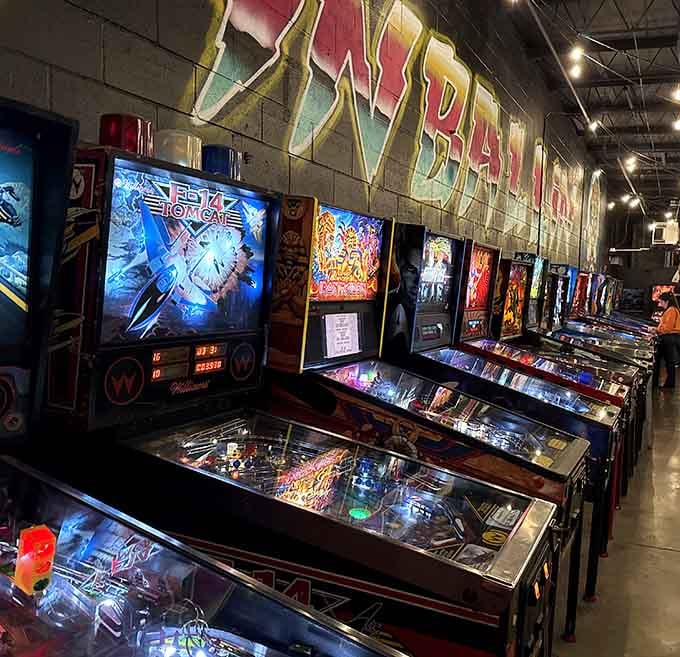 Rows of gleaming arcade machines stand ready like soldiers of fun, waiting to devour your afternoon and loving every minute.