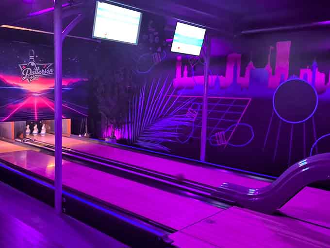 Those purple and pink lights aren't just for show, they're setting the mood for duckpin glory.