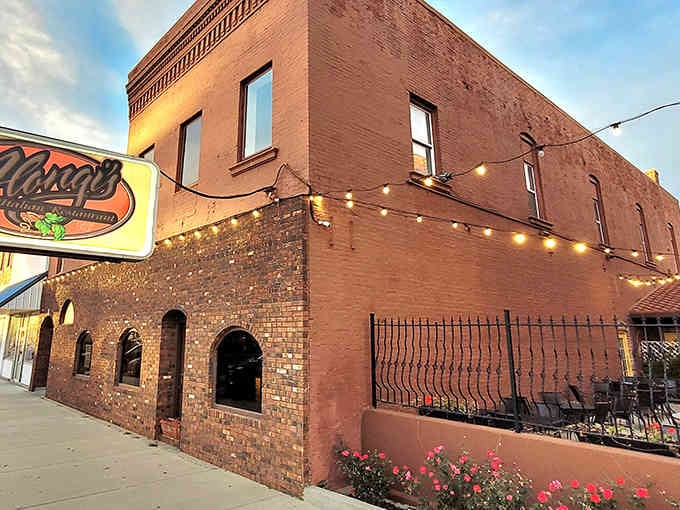 That brick exterior has witnessed nearly nine decades of pizza history, and those arched windows have seen it all.