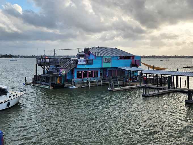 That turquoise and wood exterior isn't just Instagram bait, it's your beacon to Texas's only floating bar experience.