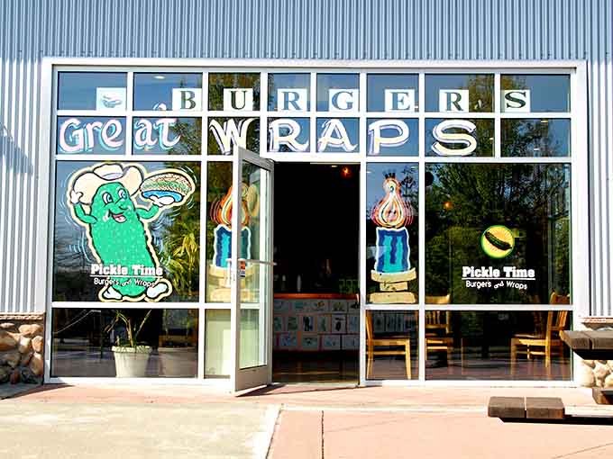 That cheerful pickle mascot in the window isn't just decoration, it's a promise of delicious absurdity inside.