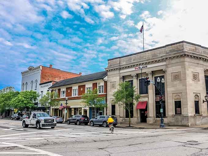Historic storefronts line the streets where American flags wave and hanging flower baskets add splashes of color overhead.