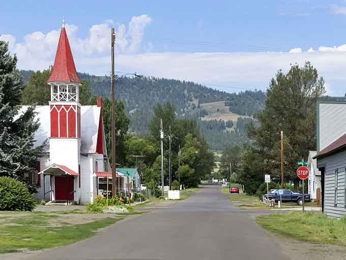 A red-steepled church anchors the street view, reminding you that some towns still build around community gathering places.