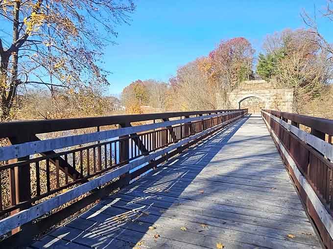 That historic stone arch framing your path ahead? Pure Connecticut charm meeting functional beauty in perfect harmony.