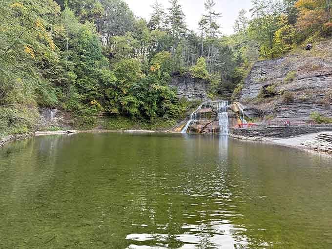 Those layered rock walls frame the falls like a natural amphitheater, autumn colors adding the perfect seasonal touch.