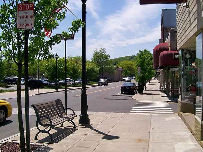 Tree-lined sidewalks and benches invite leisurely strolls where rushing is optional and people-watching is complimentary entertainment.